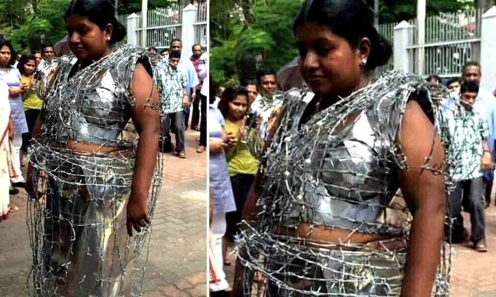 Woman protests by displaying her Anti rape dress in steel barbed wire