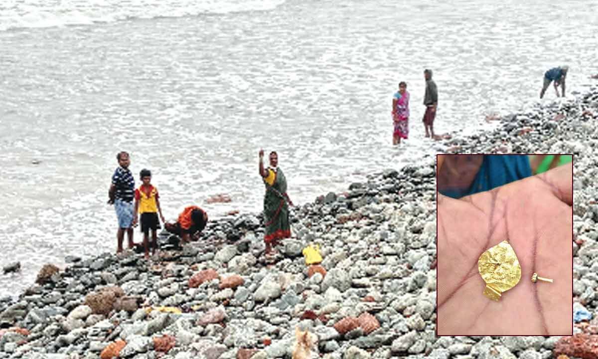 Braving cyclone, fishermen busy searching gold coins at seashore
