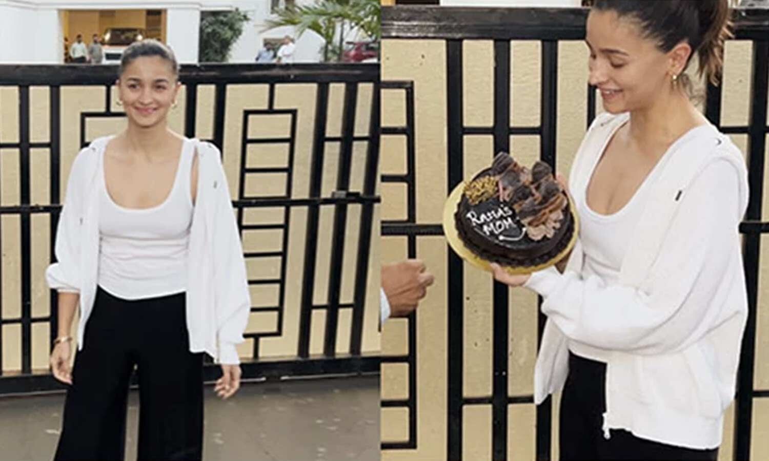 Alia can't stop smiling as she cuts a cake with "Raha's mom" written on it