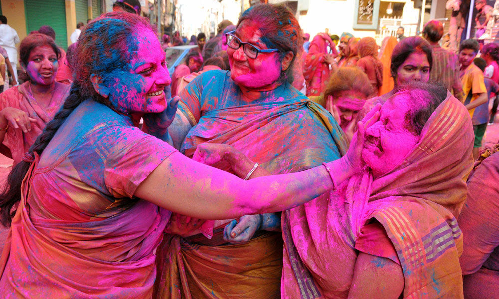 People celebrating Holi festival in the city
