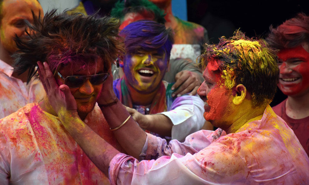 People celebrating Holi festival in the city