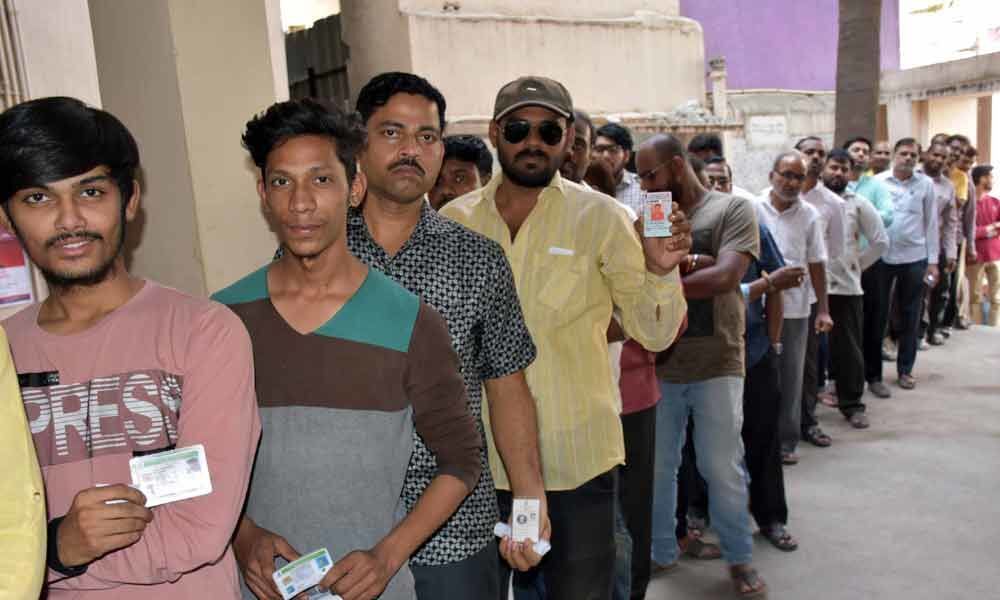 Voters wait in queues at different polling stations in the Old City to ...